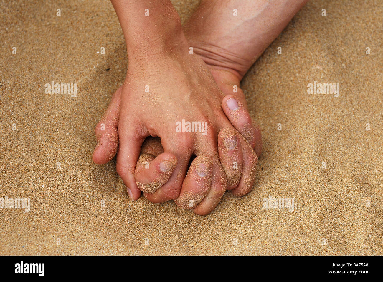 Sand hands hand in hand Stock Photo - Alamy