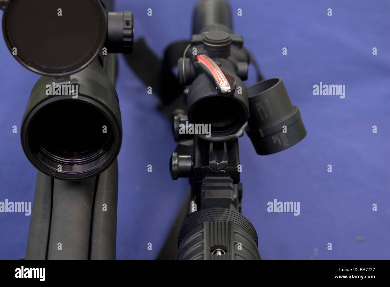 Two rifles side by side displaying thier individual sighting optics ...
