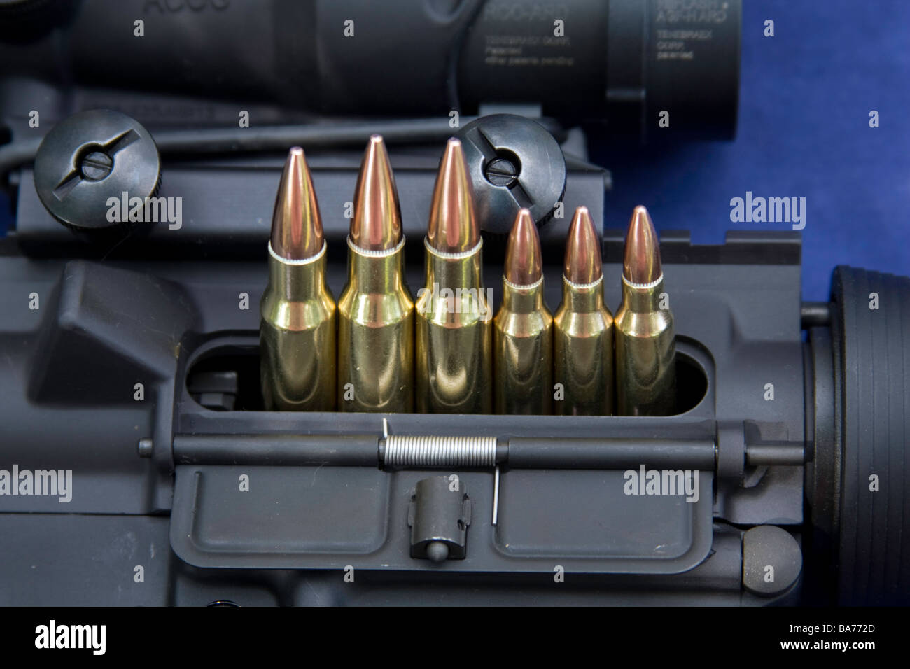 Different bullets stand ready in the chamber of an automatic rifle ...