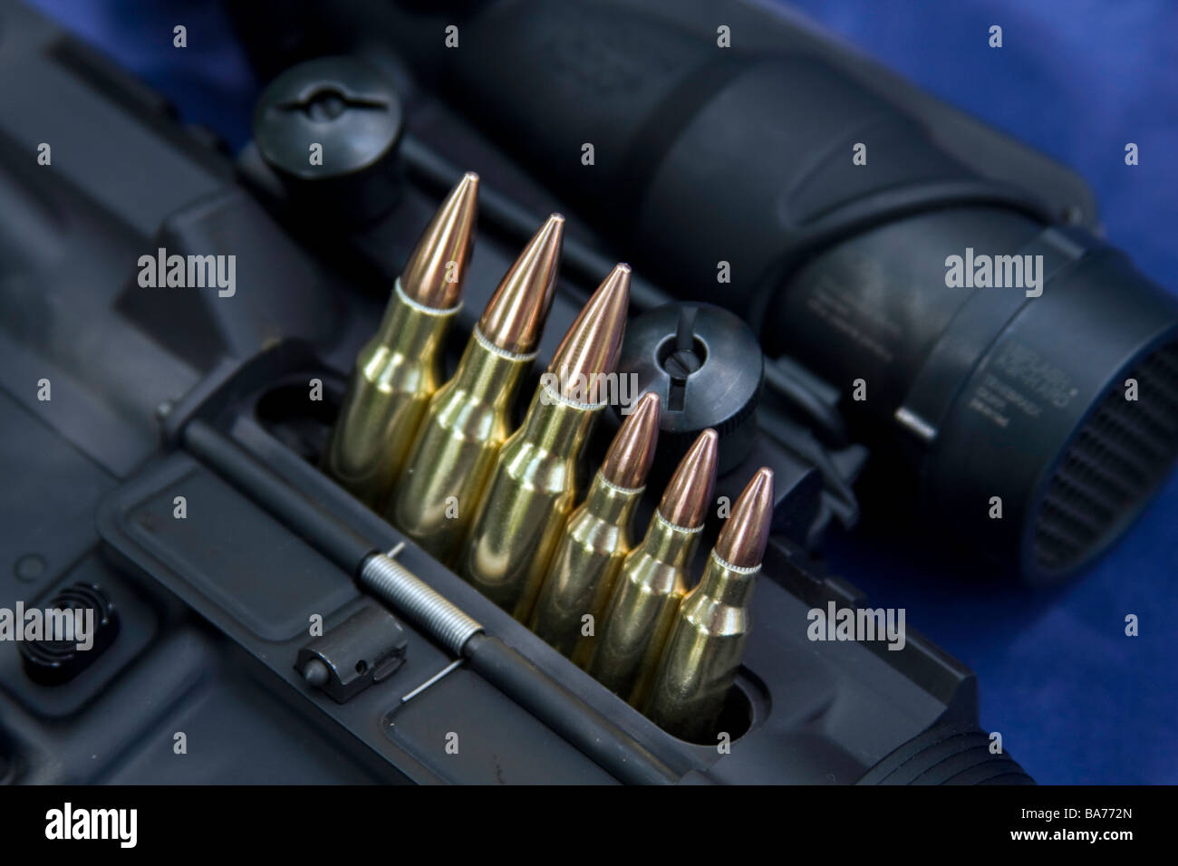 Different bullets stand ready in the chamber of an automatic rifle ...