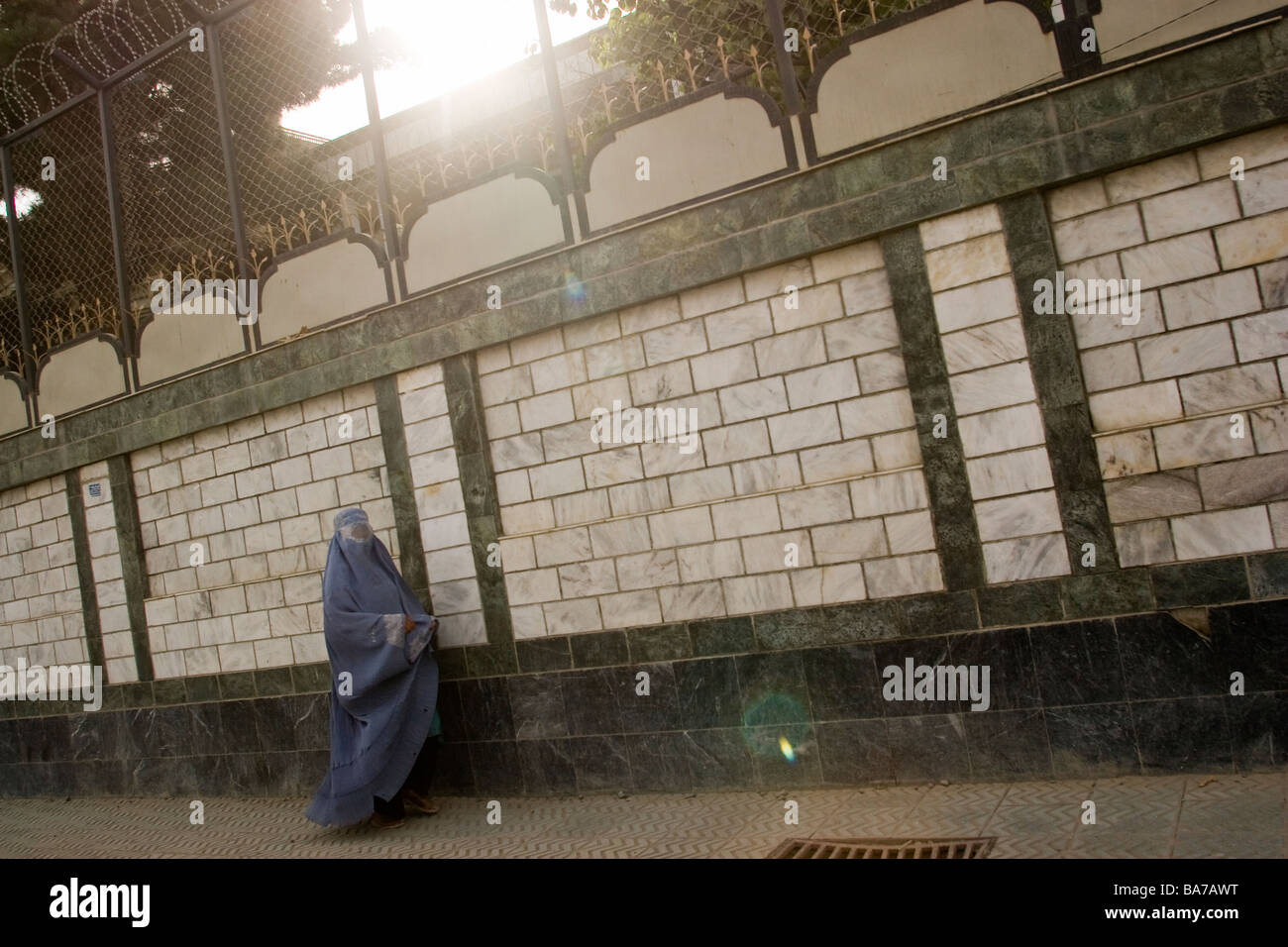 A woman in a burqa walks along the road in Kabul Afghanistan Stock ...