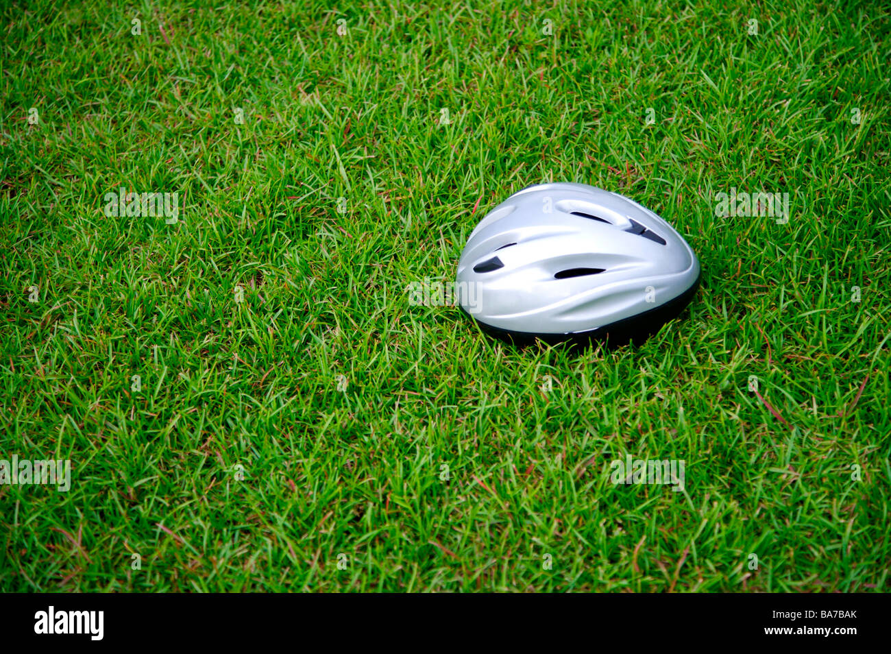 Helmet on grass Stock Photo - Alamy