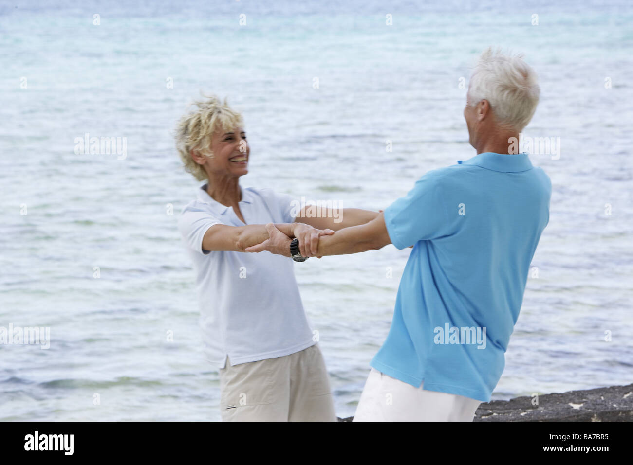 Sandy beach senior-pair movement laughs cheerfully detail series people ...