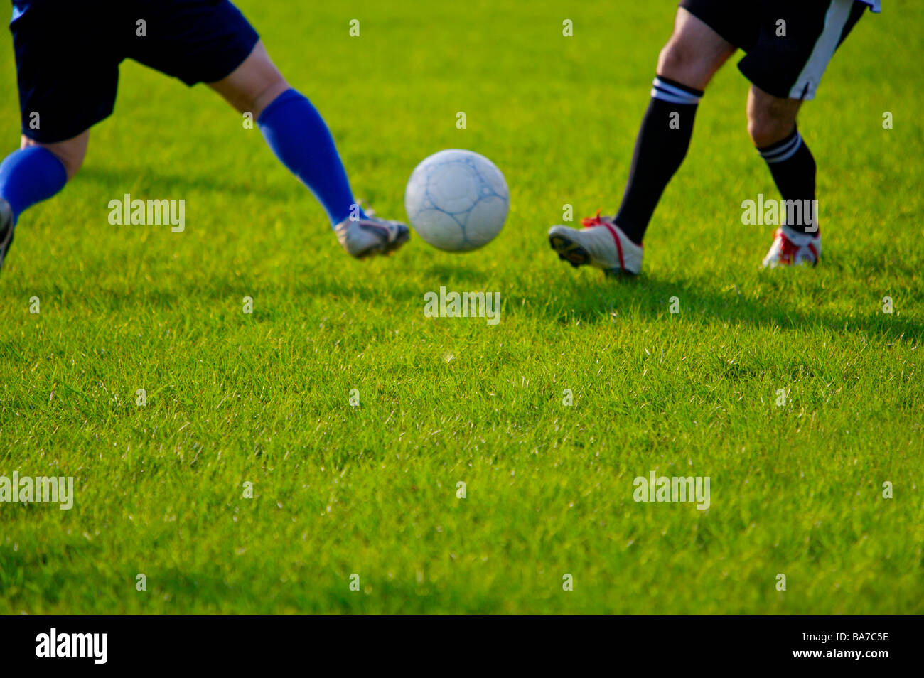 Two men playing soccer mid section Stock Photo - Alamy