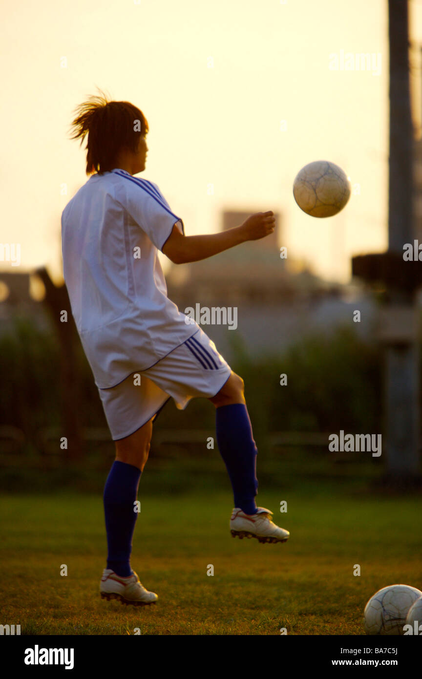 Young man playing soccer Stock Photo - Alamy