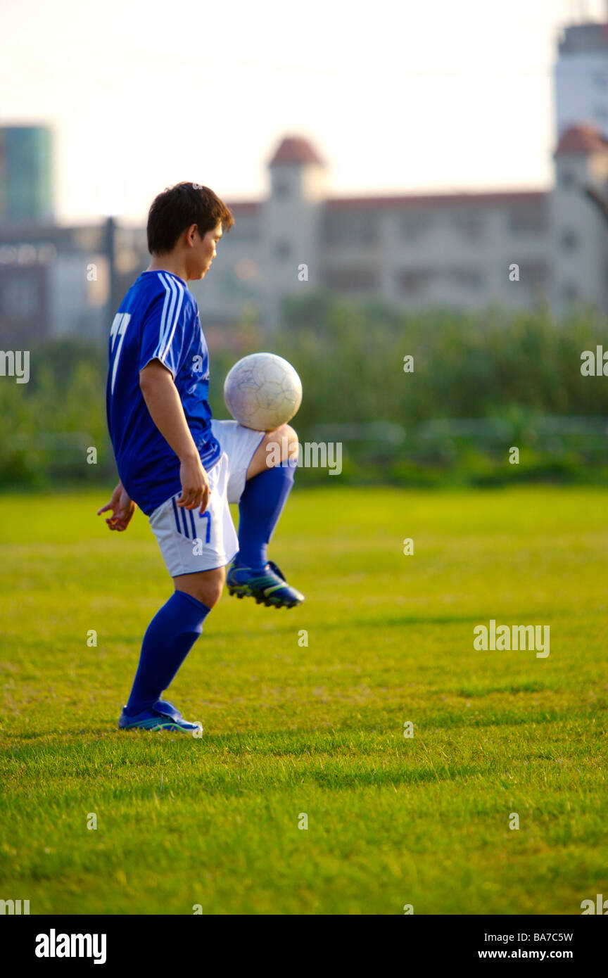 Soccer ball on player s knee Stock Photo - Alamy