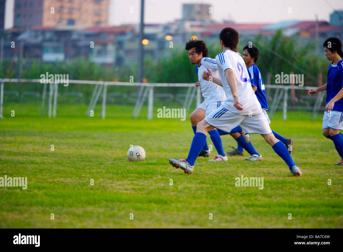 Soccer players chasing ball on field hi-res stock photography and ...