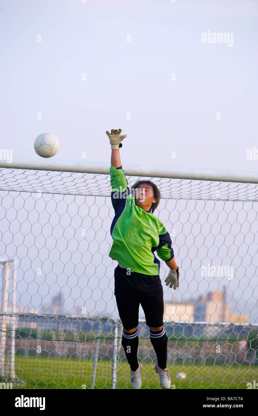 Football goalie diving for ball Stock Photo - Alamy