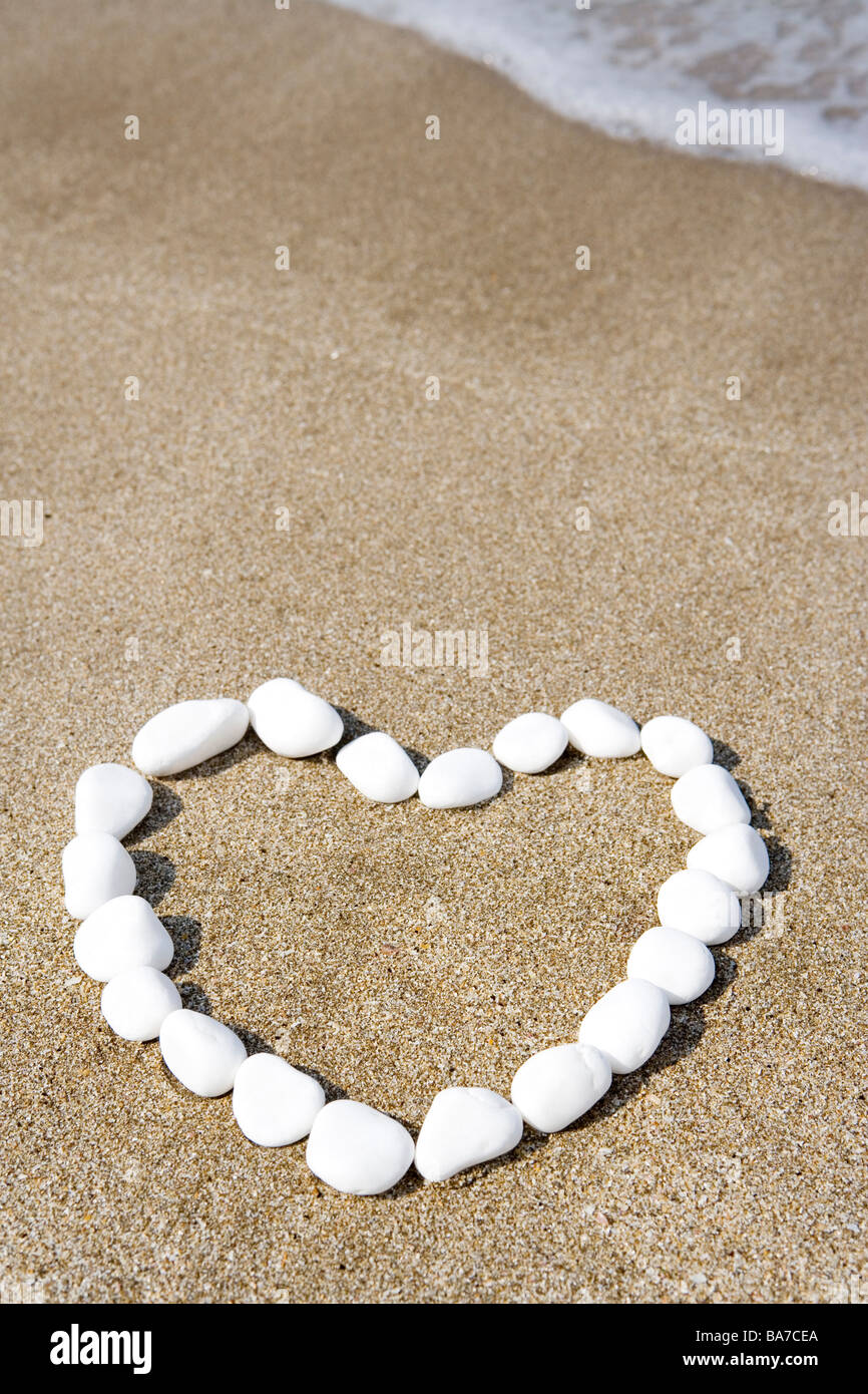 White stone form heart shape on beach Stock Photo - Alamy