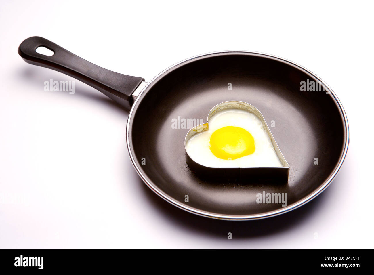 Heart shaped fried egg on pan Stock Photo - Alamy