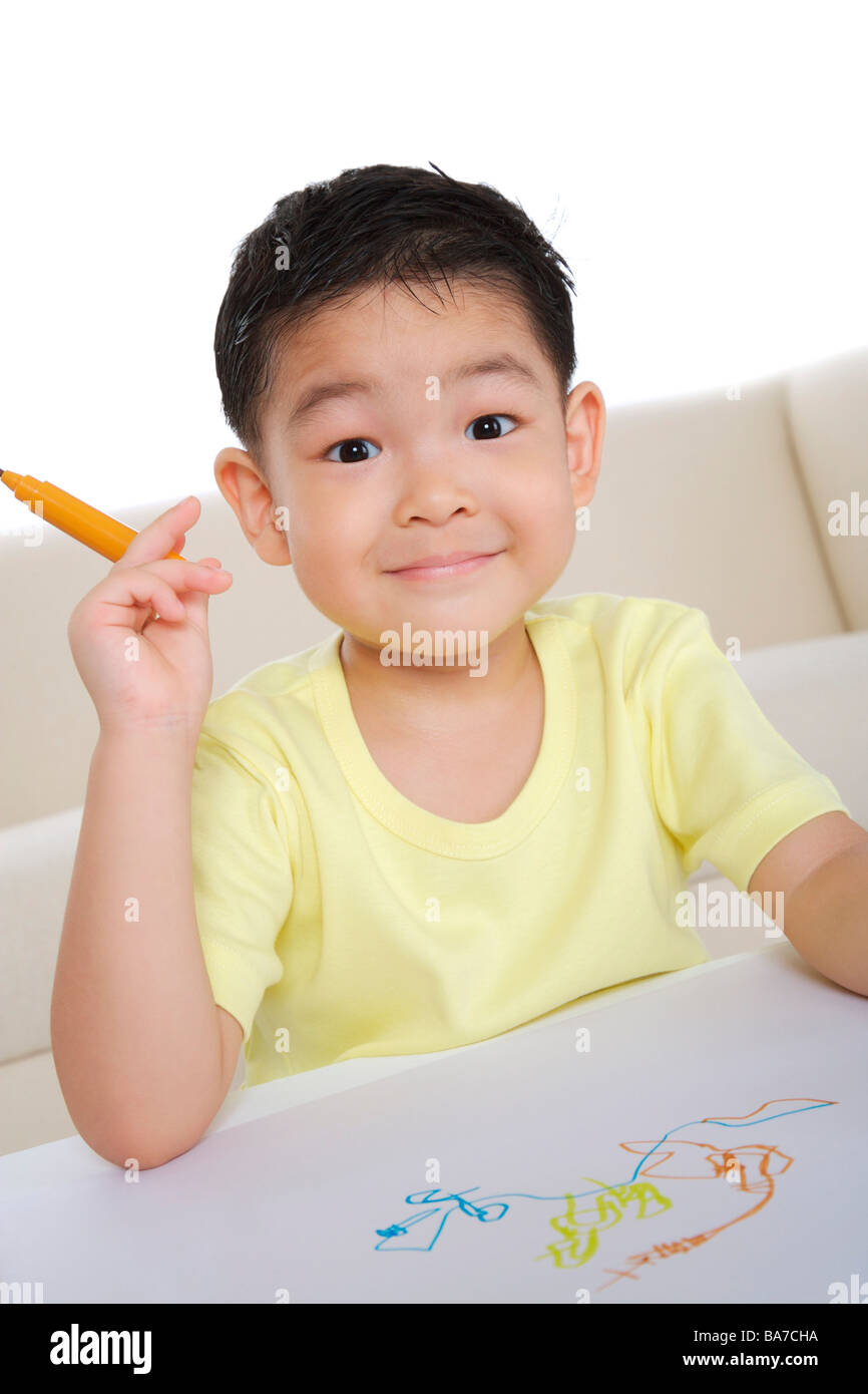 Boy drawing on paper Stock Photo - Alamy