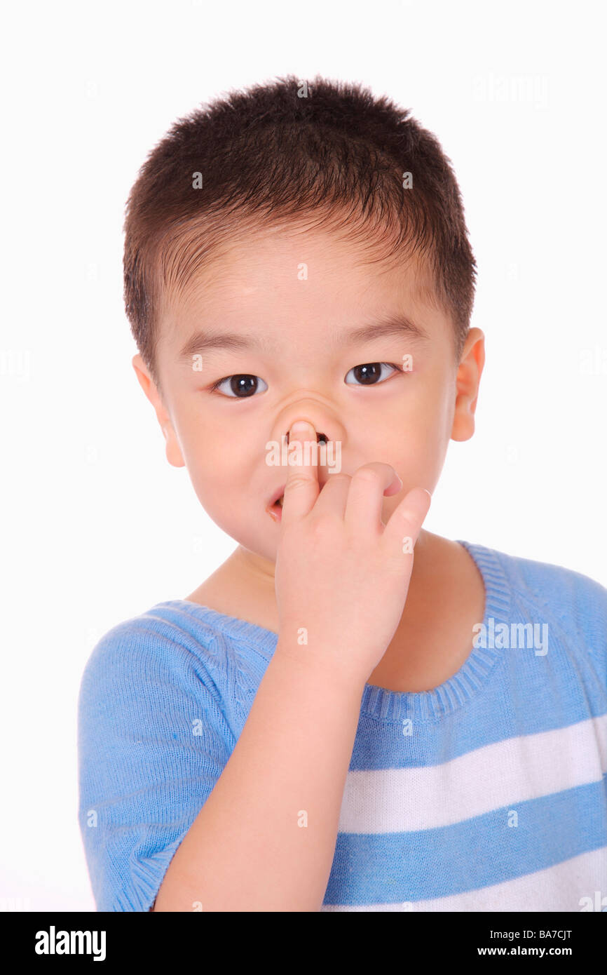 Boy touching his nose close up portrait Stock Photo - Alamy