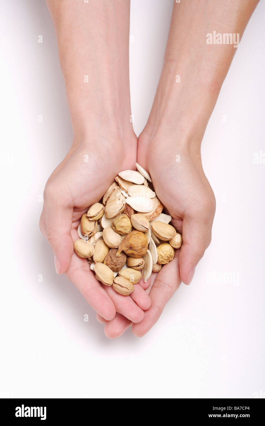 Close up of hands holding with nuts Stock Photo - Alamy