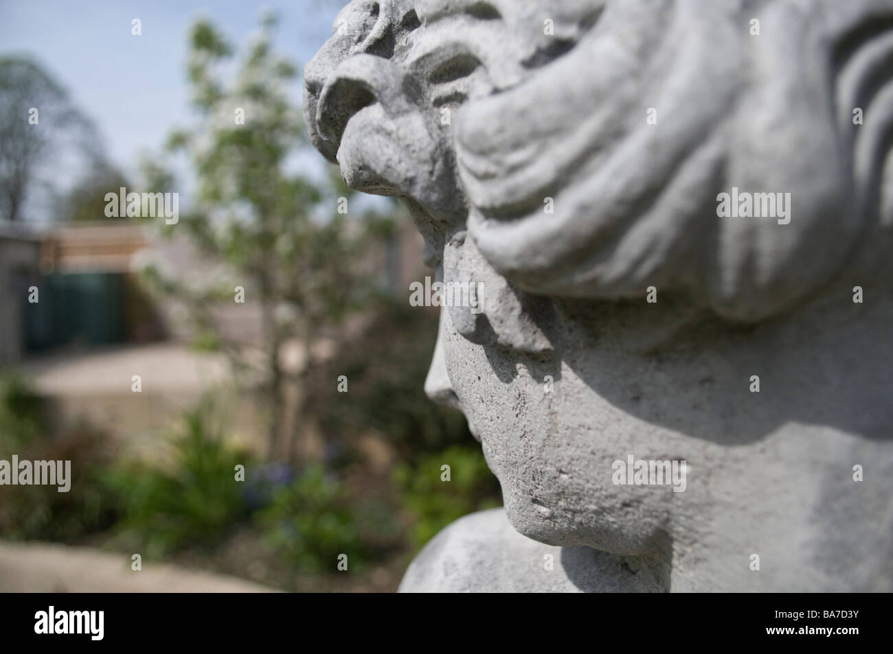 Head of a garden statue turned to look at the garden Stock Photo - Alamy