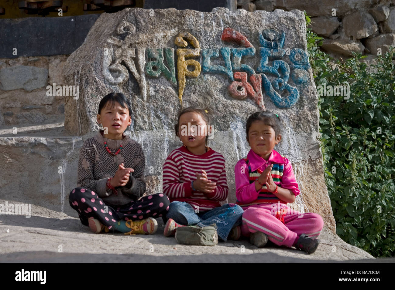 three girls singing for money outside the Sera Monastery, Lhasa, Tibet ...