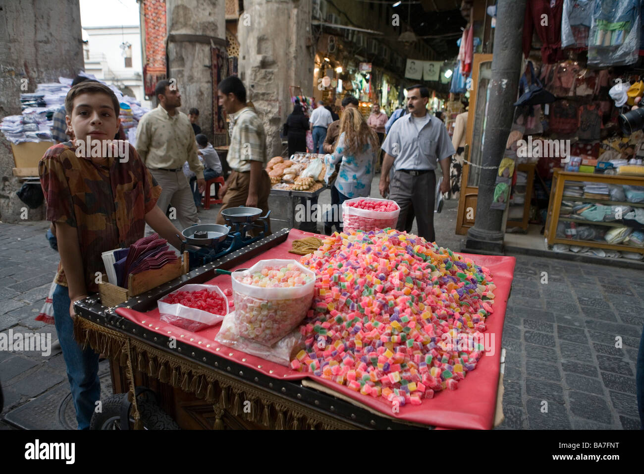 Boy with handcart with colorful candy sweets at Souq al-Hamidiyya ...