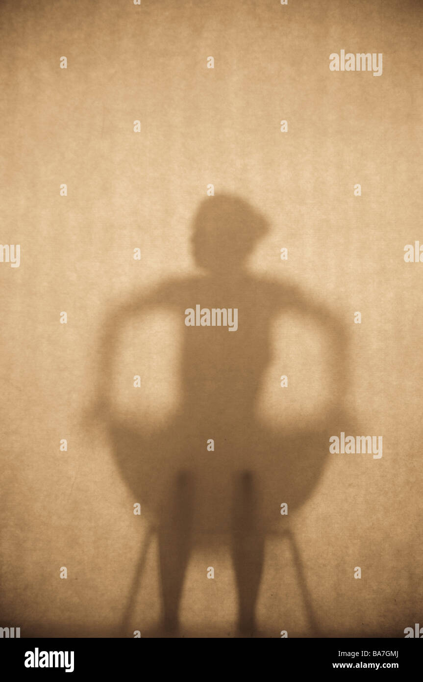 Shadow of a woman sitting on a chair Stock Photo - Alamy