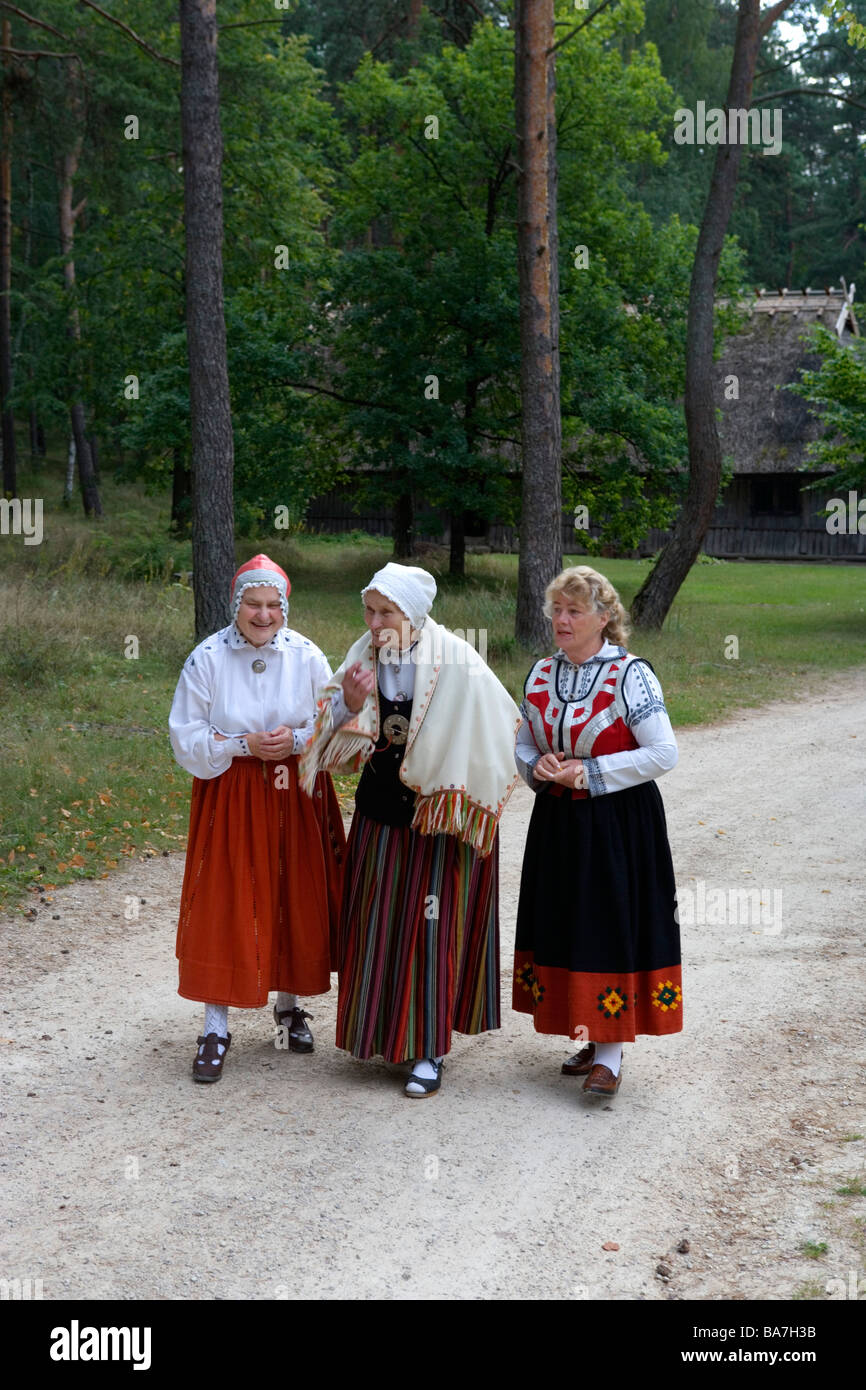 Three ladies in traditional costumes in the farm house museum of Latvia ...