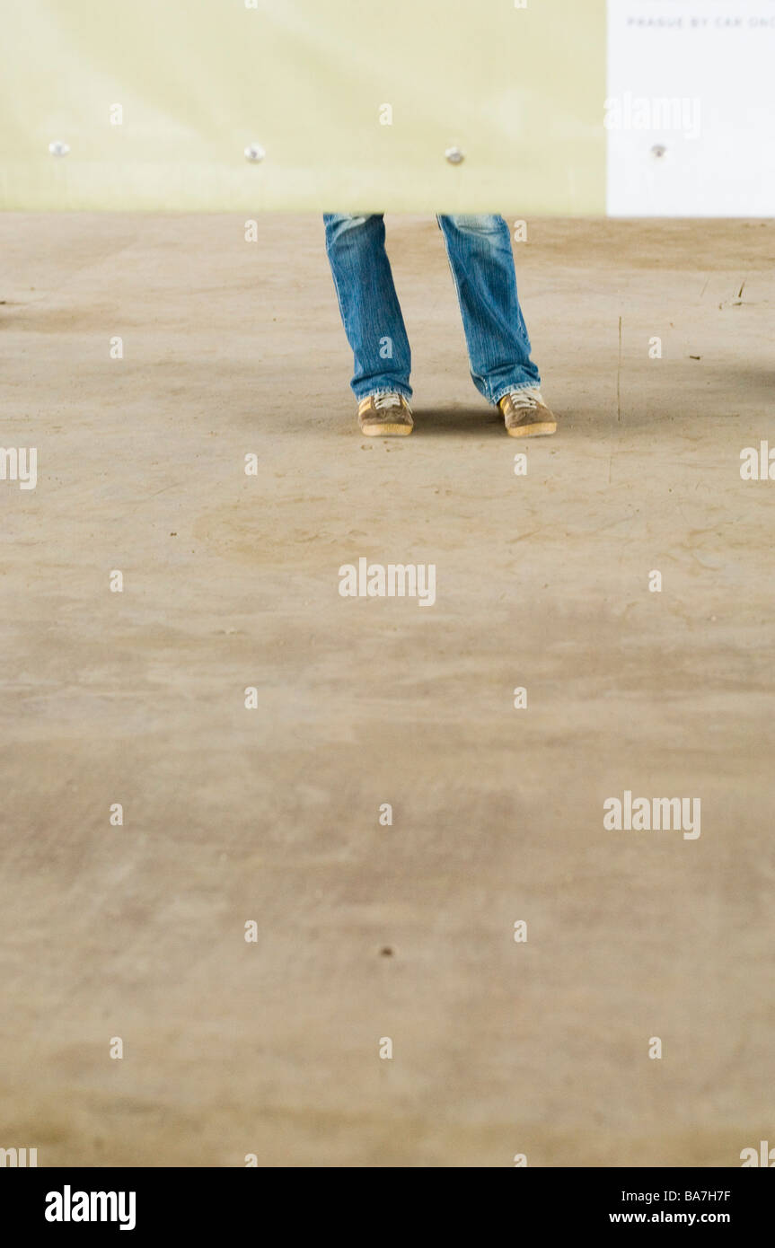 Person standing behind a billboard Stock Photo - Alamy