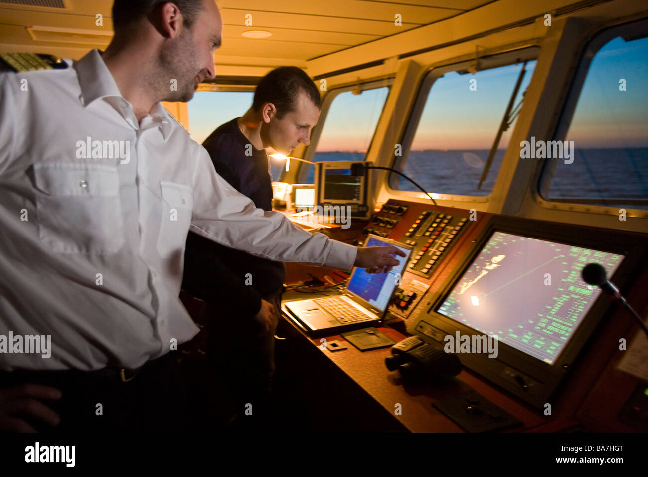 Captain and helmsman in training on the bridge of a ship, Hanse ...