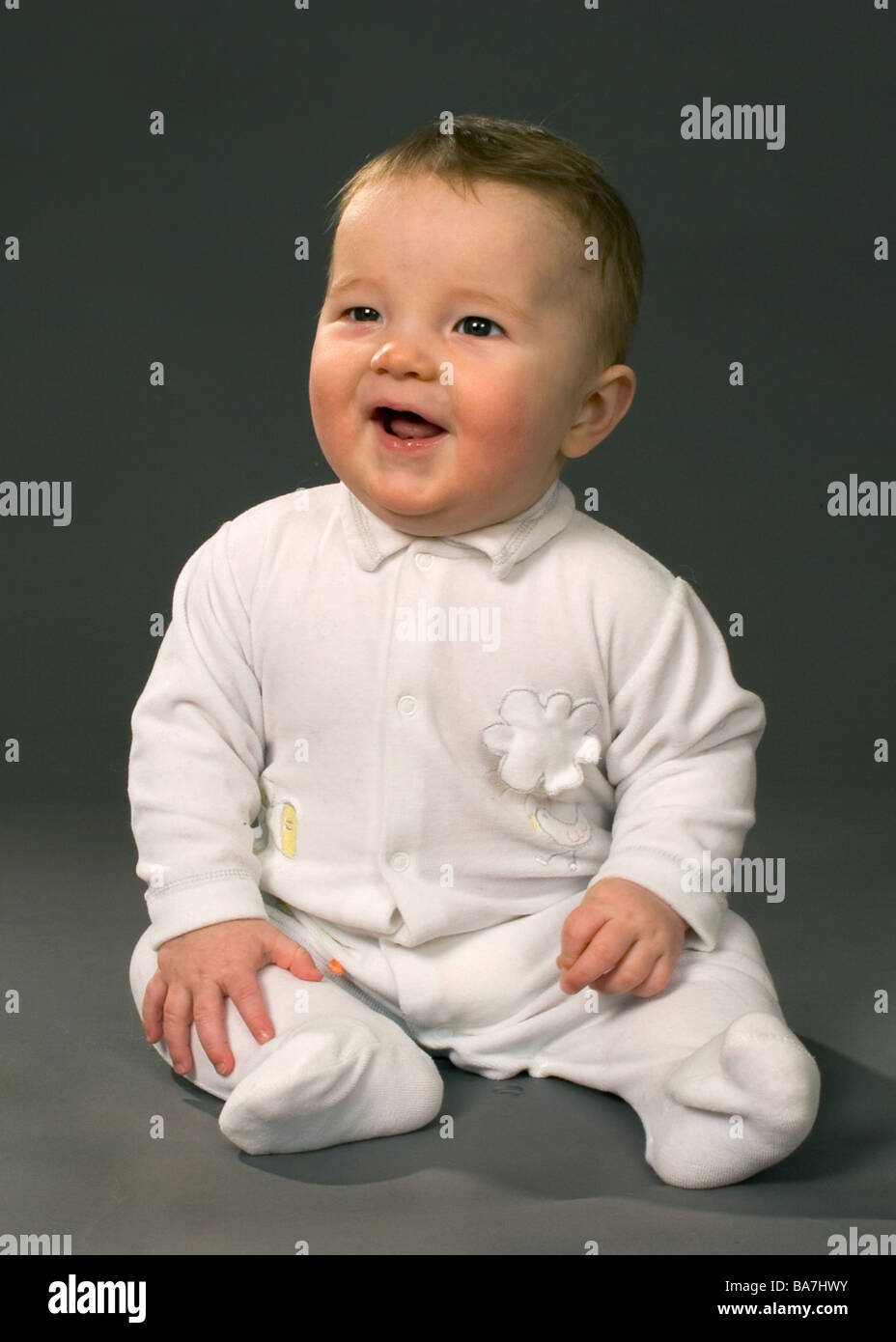 happy baby sitting in studio Stock Photo - Alamy
