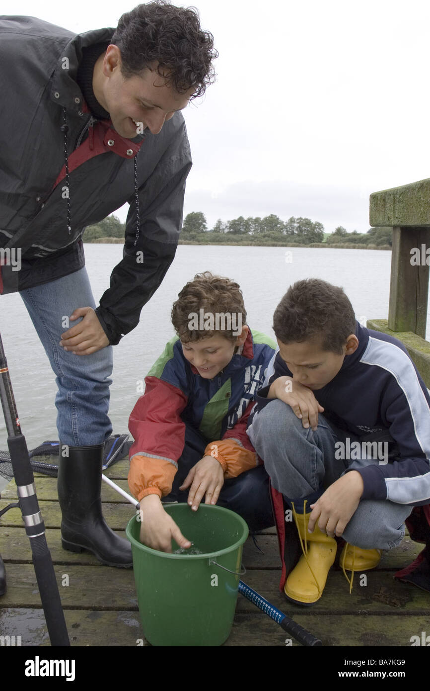 Boys on bridge fishing rod hi-res stock photography and images - Alamy