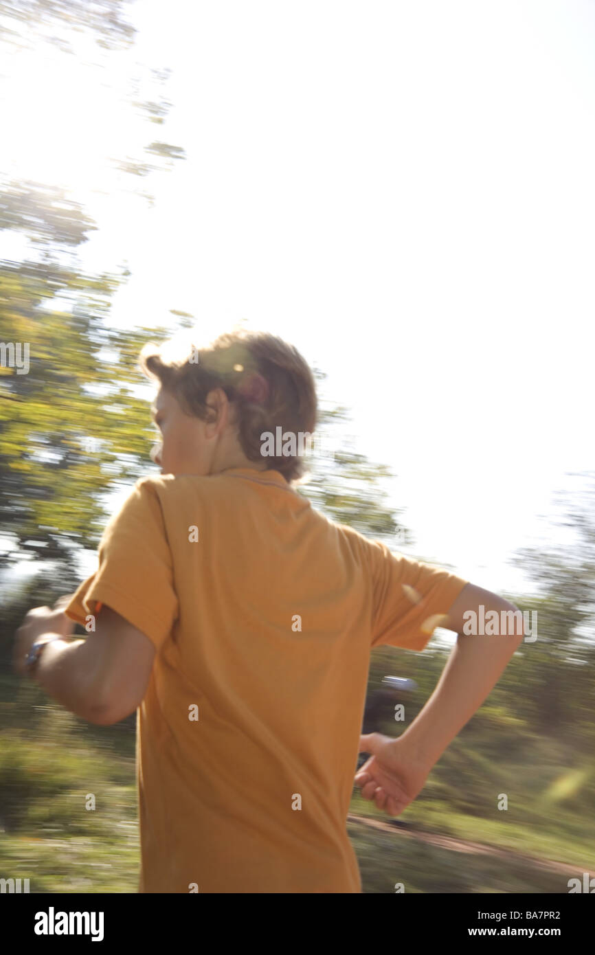 Teenager jogs semi-portrait at the side back light people boy Jogging ...