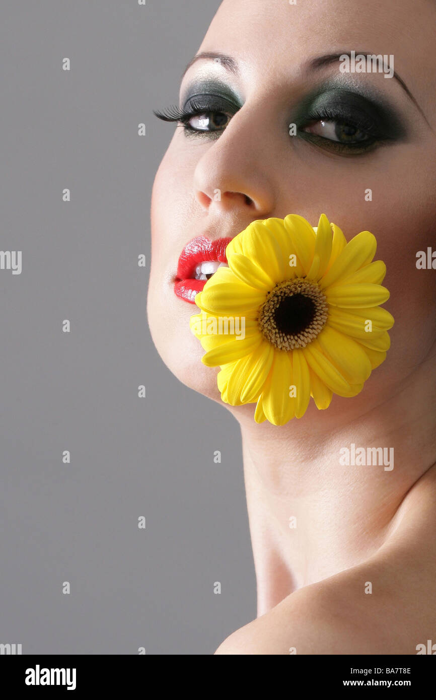 Female model with yellow flower Stock Photo - Alamy