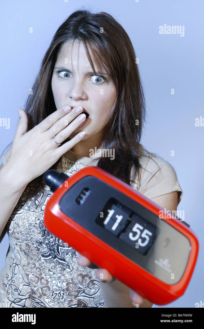 Woman young gesture startled alarm clocks five before twelve semi ...