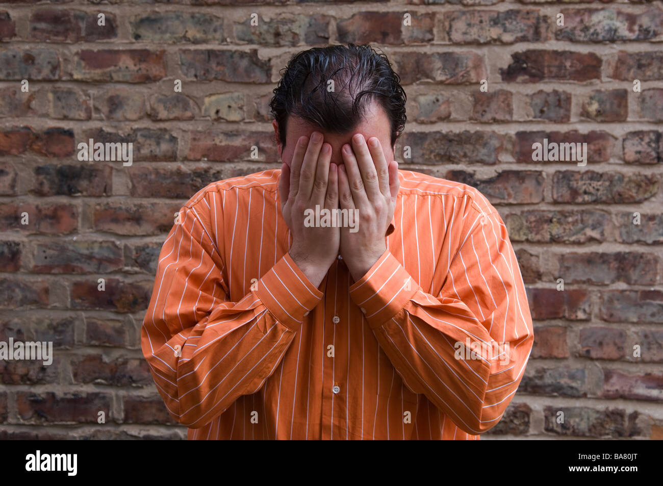 Man hiding face outdoors Stock Photo - Alamy