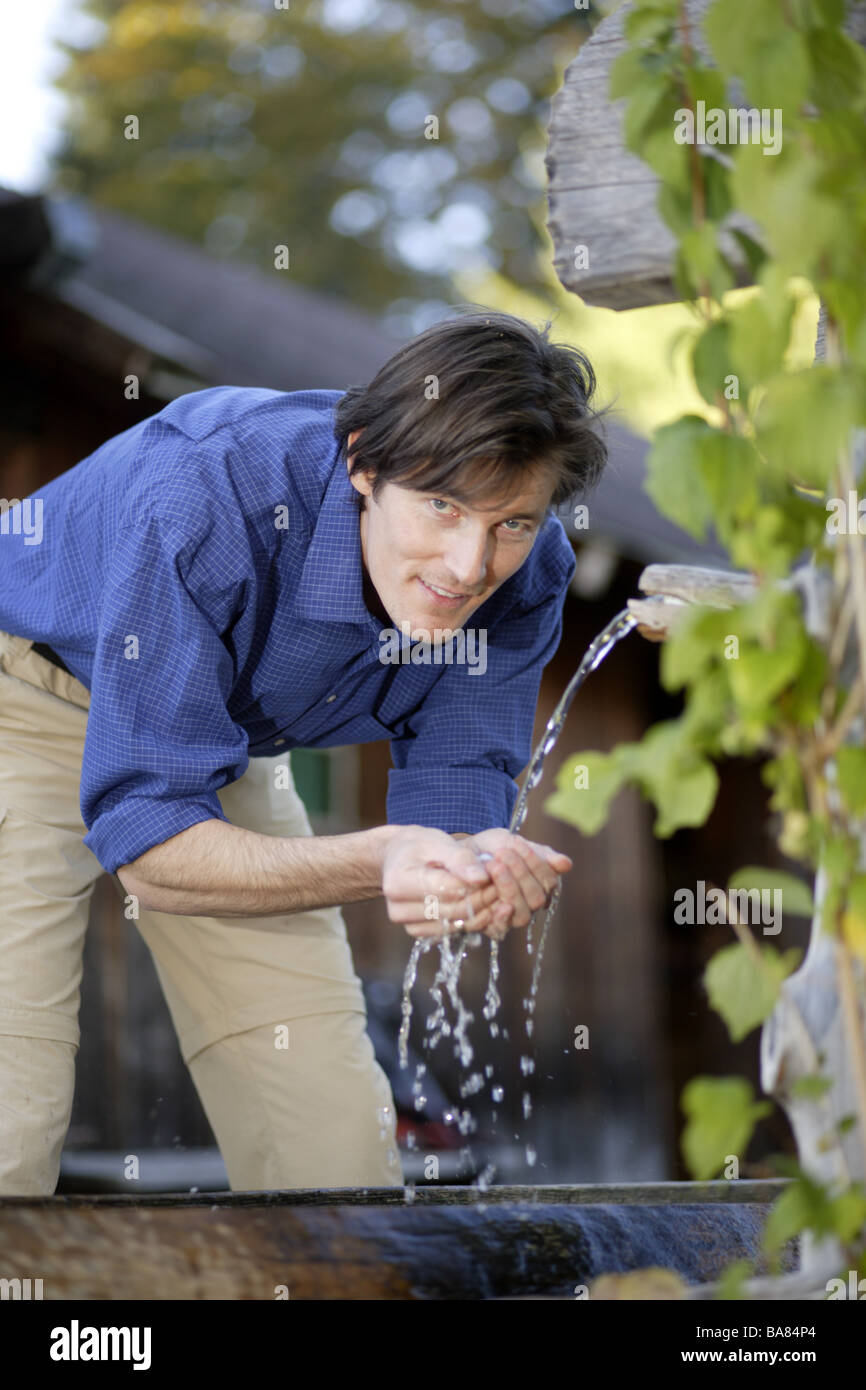 Man wells water refreshment cooling Stock Photo - Alamy