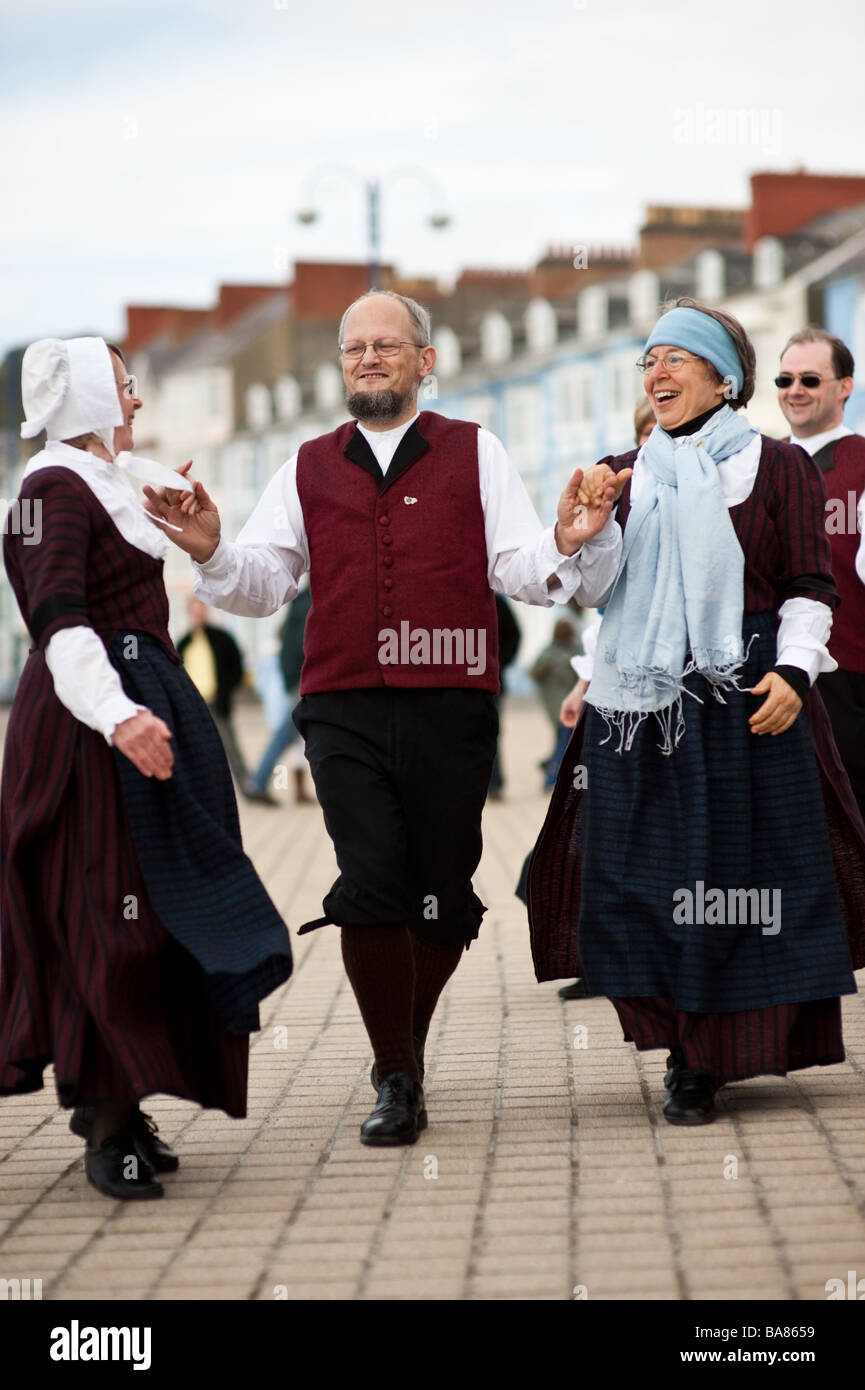 men and women doing traditional welsh folk dancing on the promenade ...