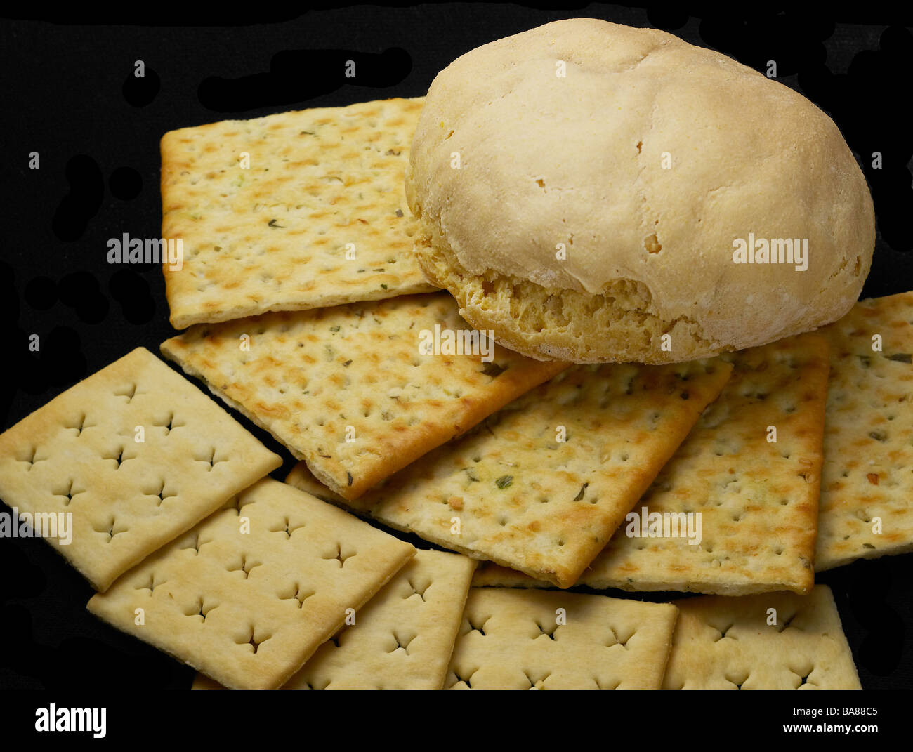 fresh bread and crackers on black background Stock Photo - Alamy