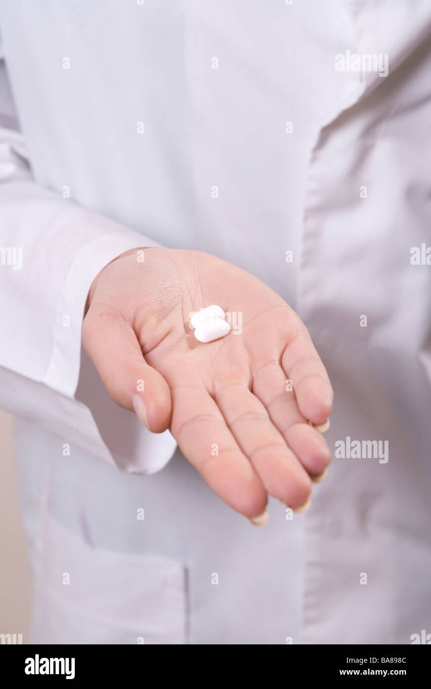 Doctor's hand giving medicine pills Stock Photo - Alamy