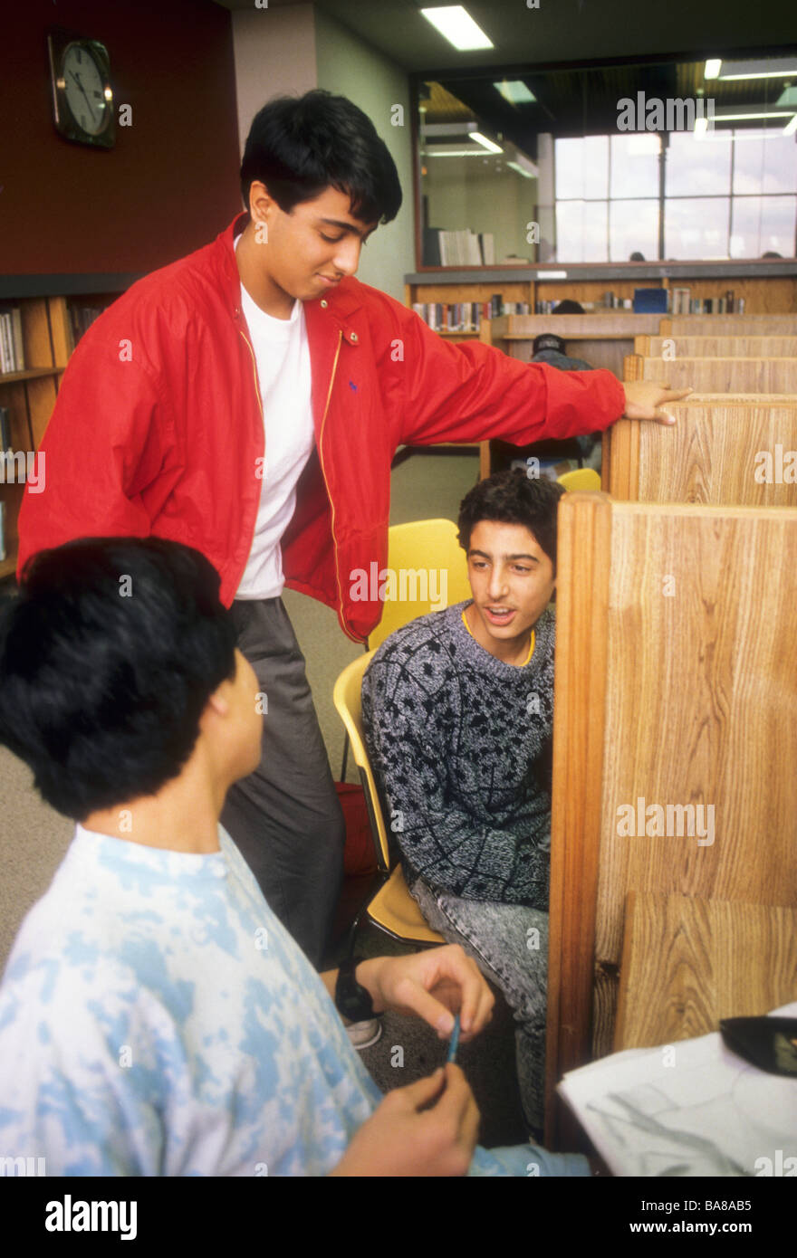 Three teen boy study read research high school library cubicle book ...