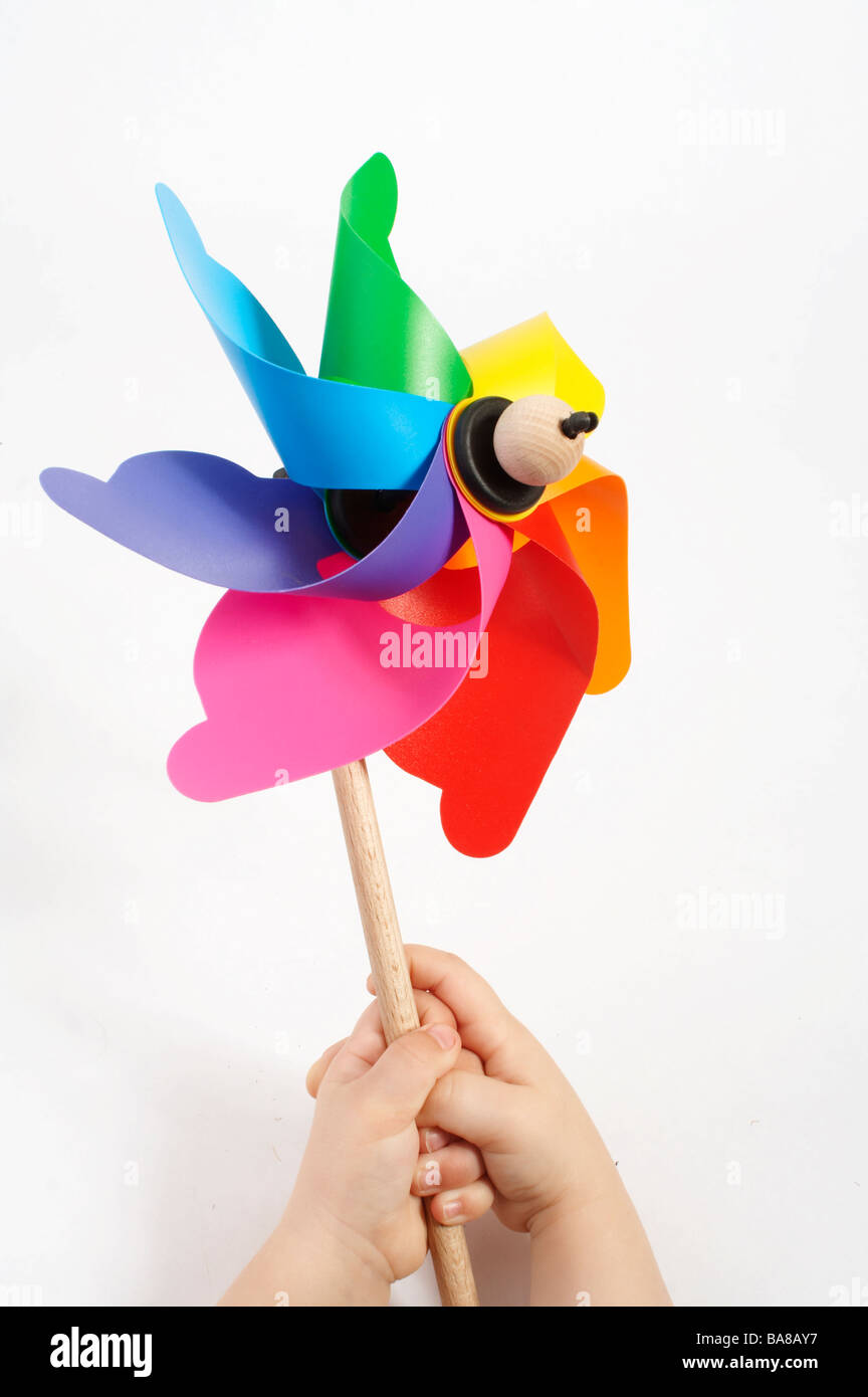 Kids Hands Holding a Windmill Stock Photo - Alamy