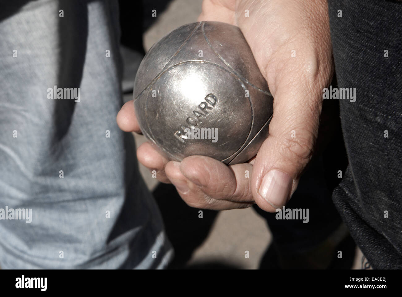 hand with metal boule ball petanque france Stock Photo - Alamy