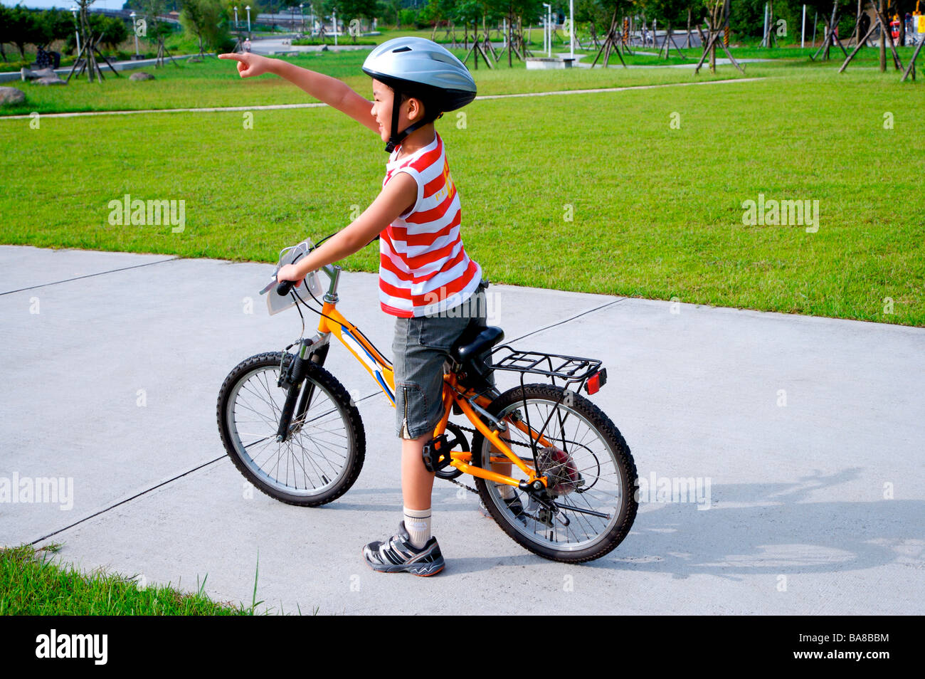 Boy standing bicycle side view hi-res stock photography and images - Alamy