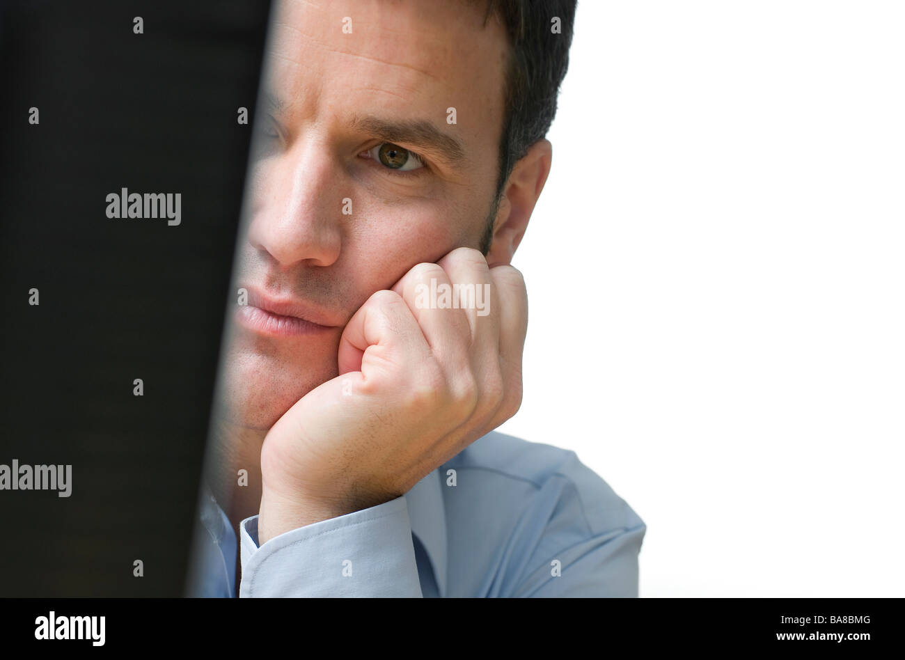 man looking at computer monitor Stock Photo - Alamy