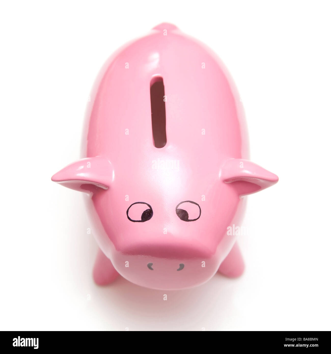 Pink piggy bank style money box isolated on a white studio background ...