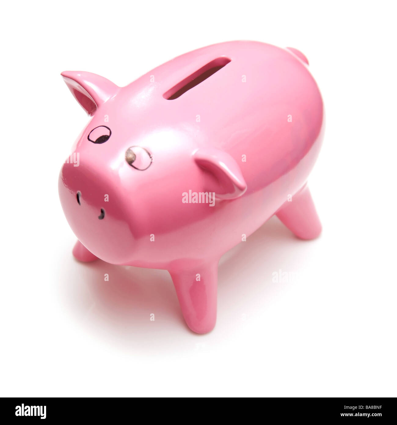 Pink piggy bank style money box isolated on a white studio background ...