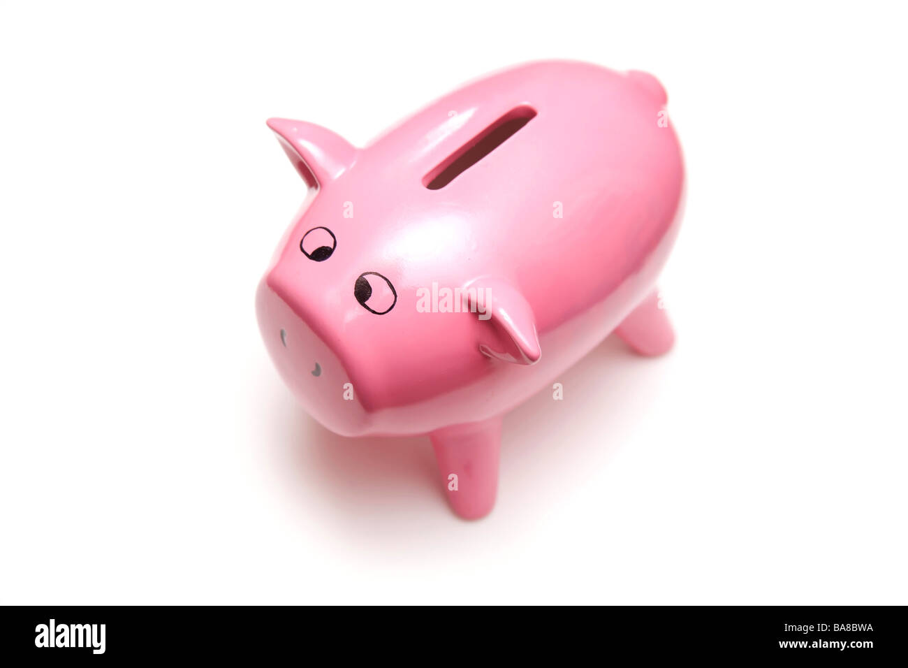 Pink piggy bank style money box isolated on a white studio background ...
