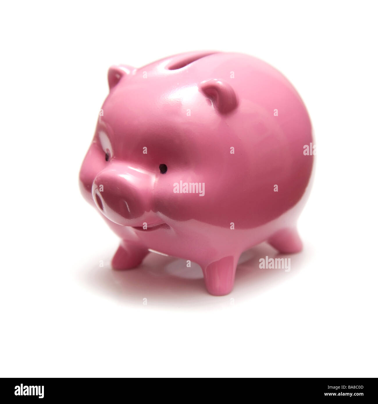 Pink piggy bank style money box isolated on a white studio background ...