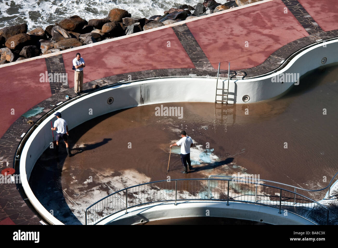 Clearing the pool of silt after the tropical storm in Funchal Madeira ...