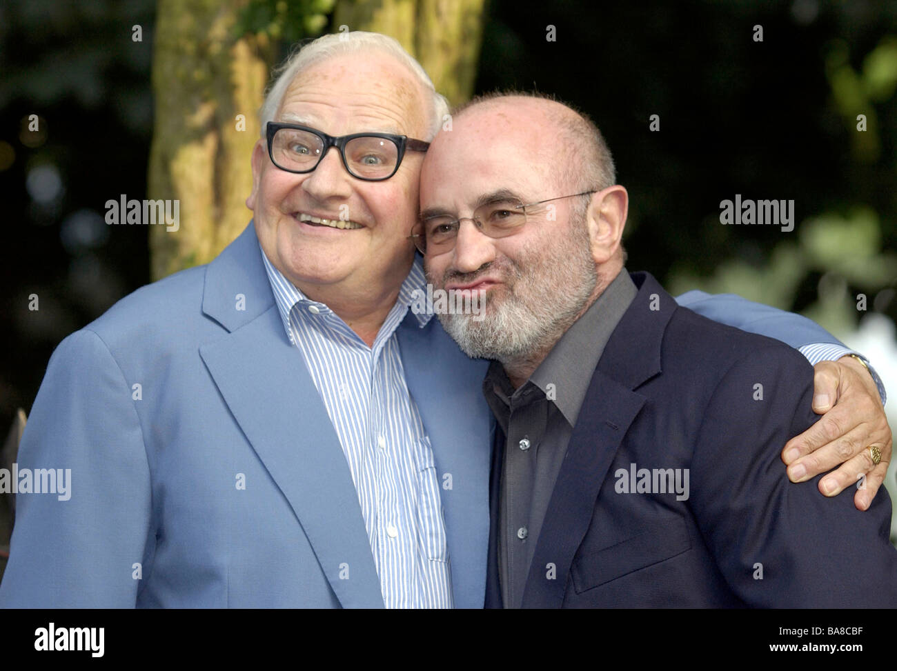 ACTOR BOB HOSKINS AND COMEDIAN RONNIE BARKER FOOLING AROUND AT SOCIETY ...