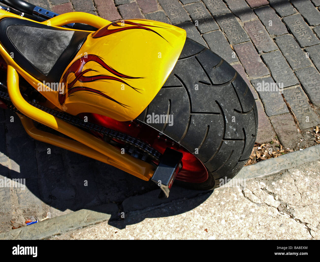 motorcycle rear wheel and seat in yellow with customized fire paintings ...