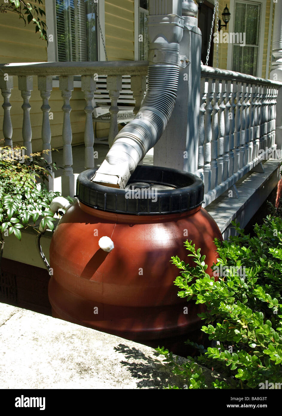water rain barrel container with downspout gutter attached to the top ...