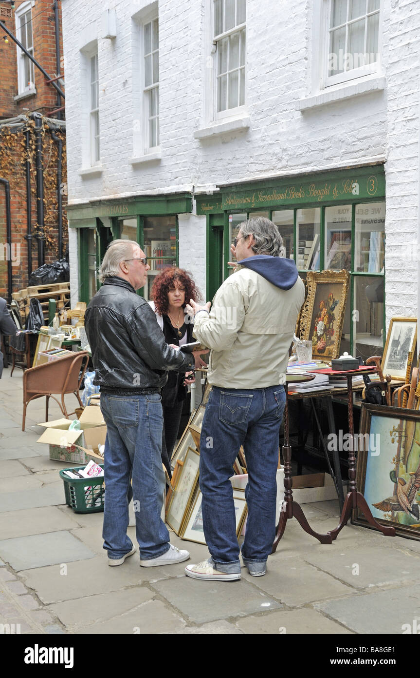 Shop owner talking to customers outside hi-res stock photography and ...