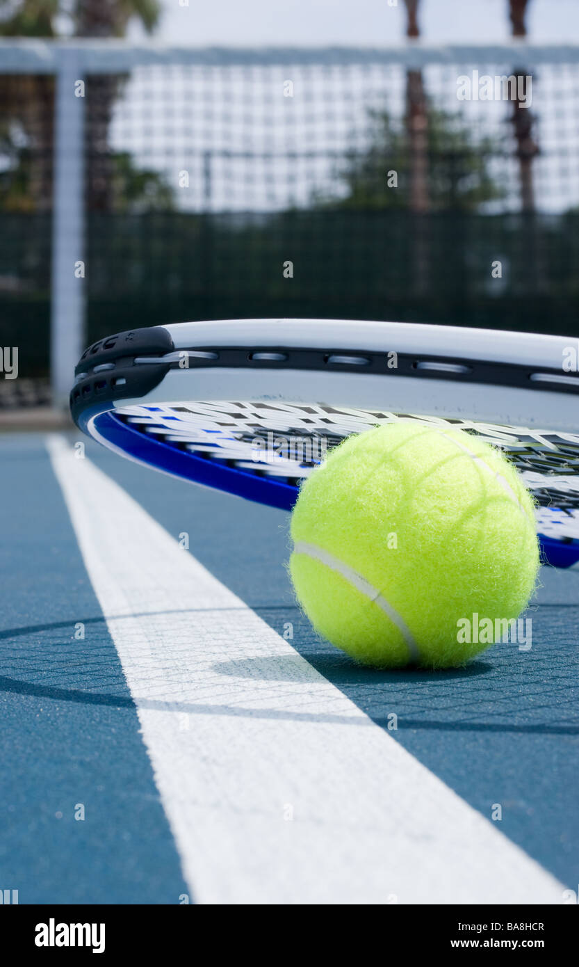 Tennis ball and racket close up on the court Stock Photo - Alamy