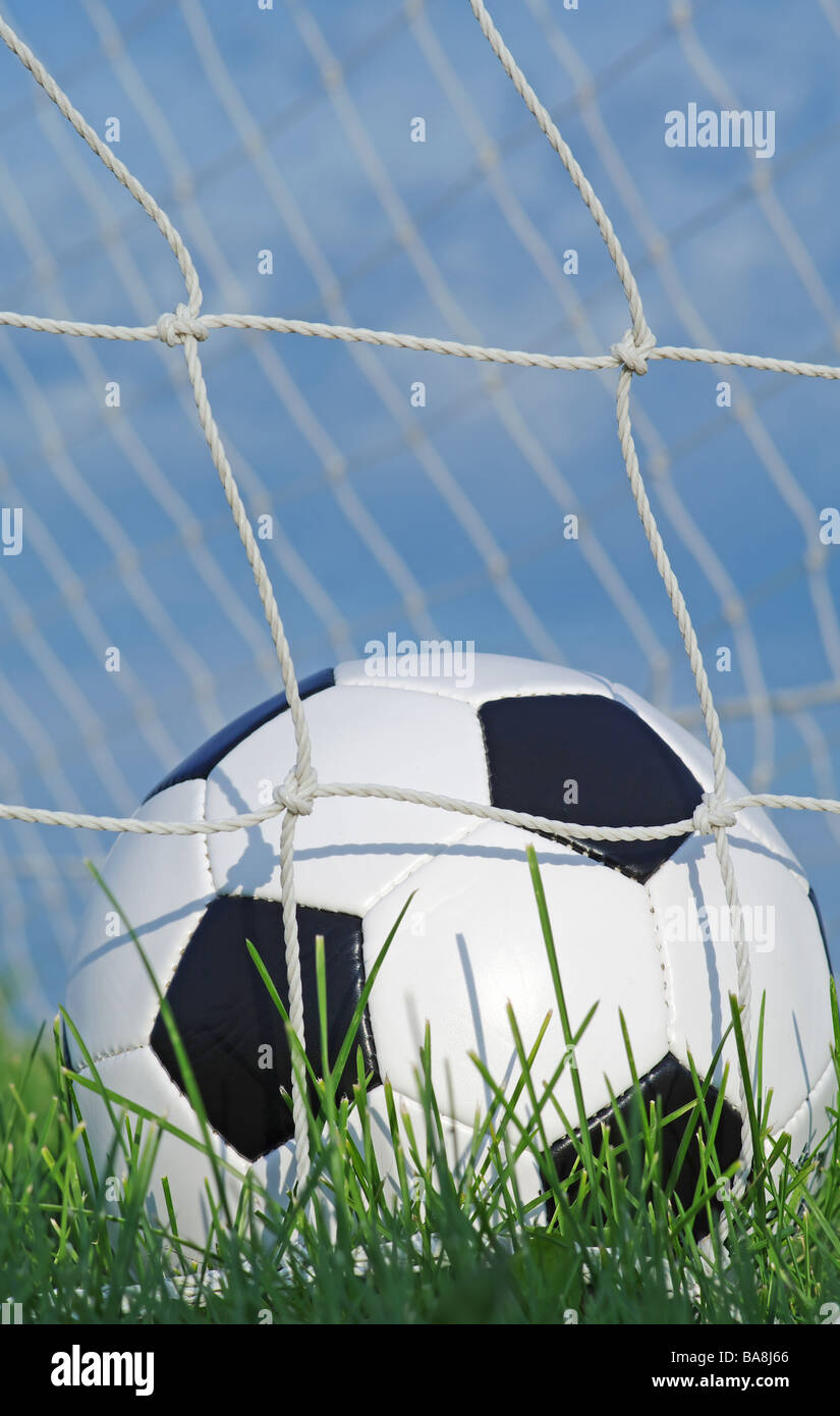 Soccer ball in the goal net Stock Photo - Alamy